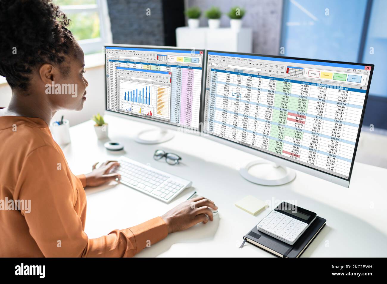 Data Analyst African Woman Using Spreadsheet On Computer Stock Photo ...