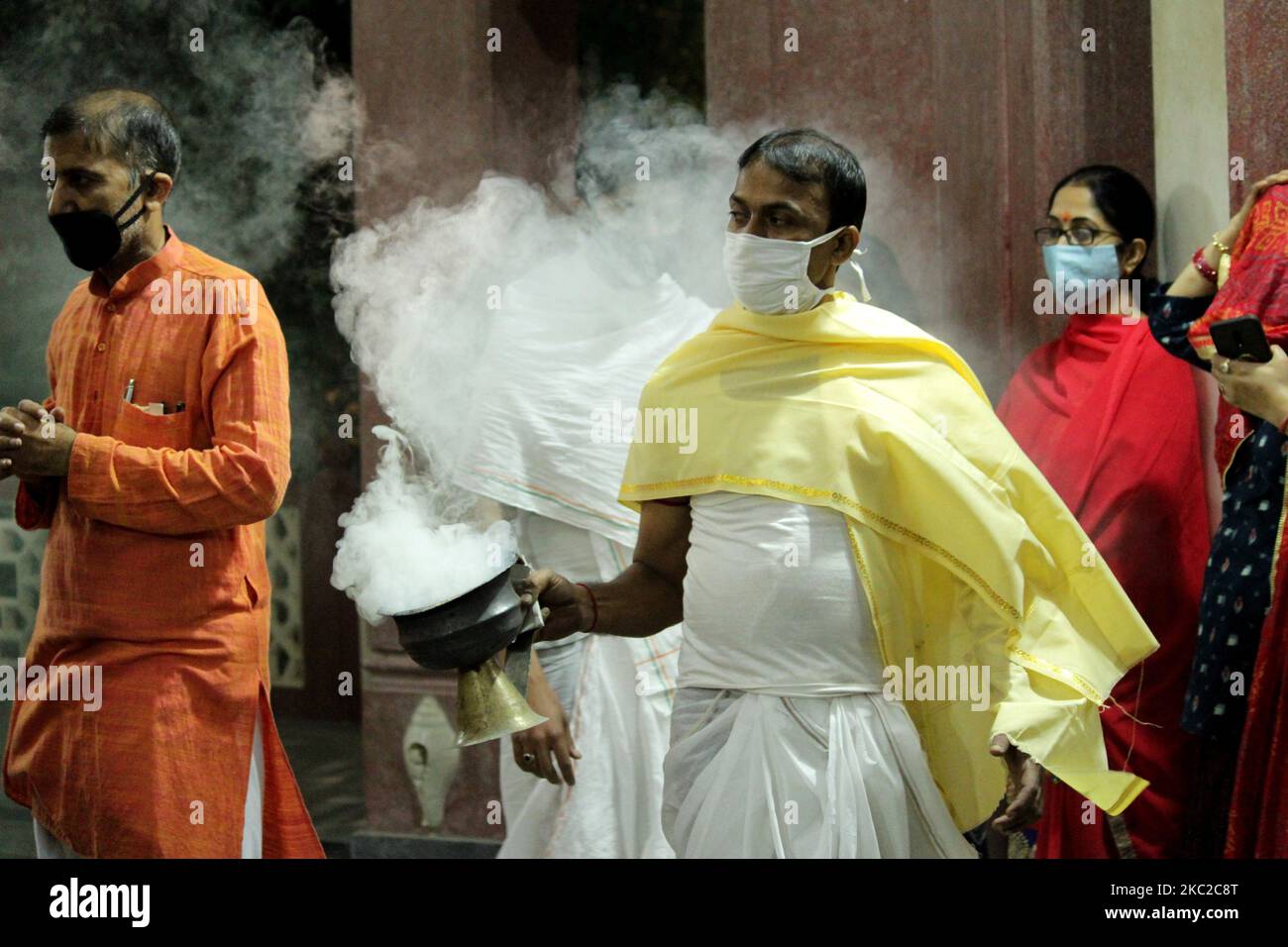 A Hindu priest wearing face mask as a precautionary measure during the ...
