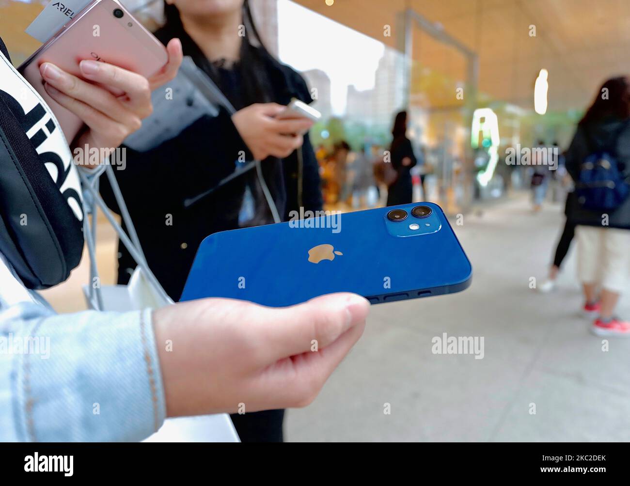 People in Taipei City take photos of Apple's newly released iPhone 12 ...