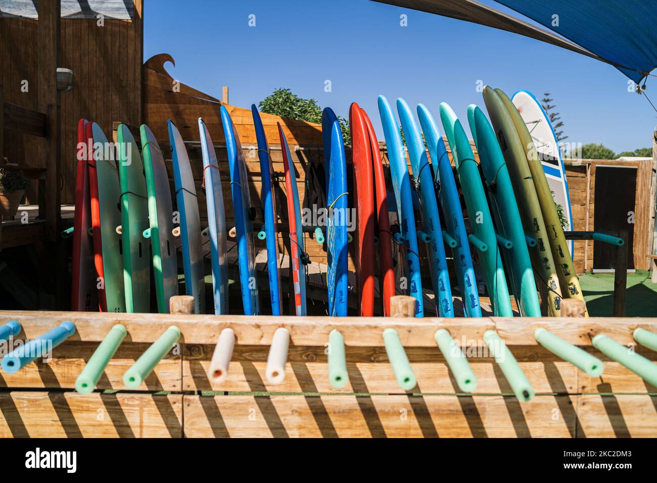 The view of colorful surfboards stacked in a decorative ship under the ...
