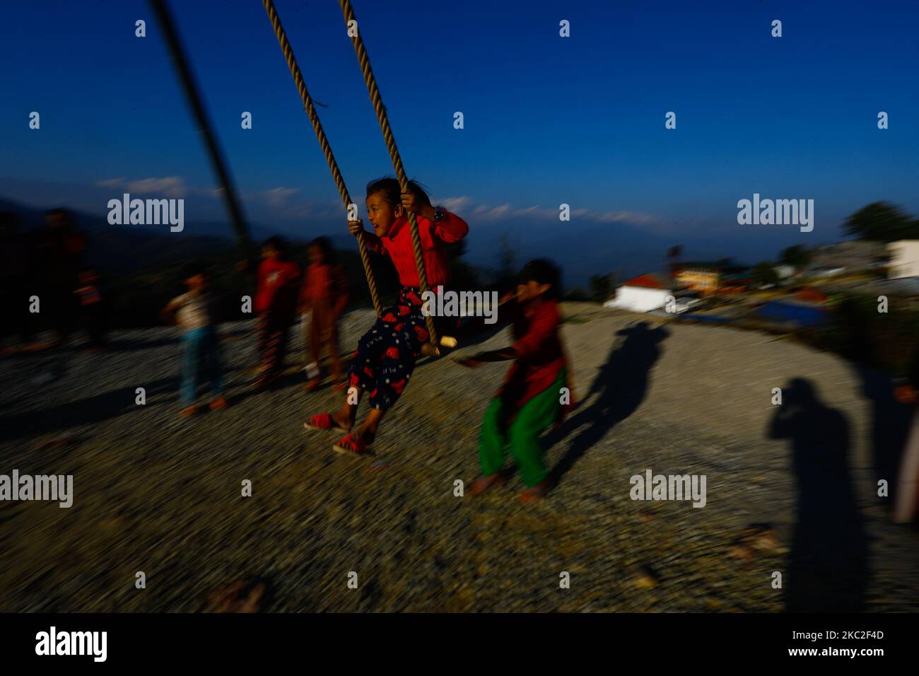 A Nepalese girl plays on a traditional swing during Dashain, the ...