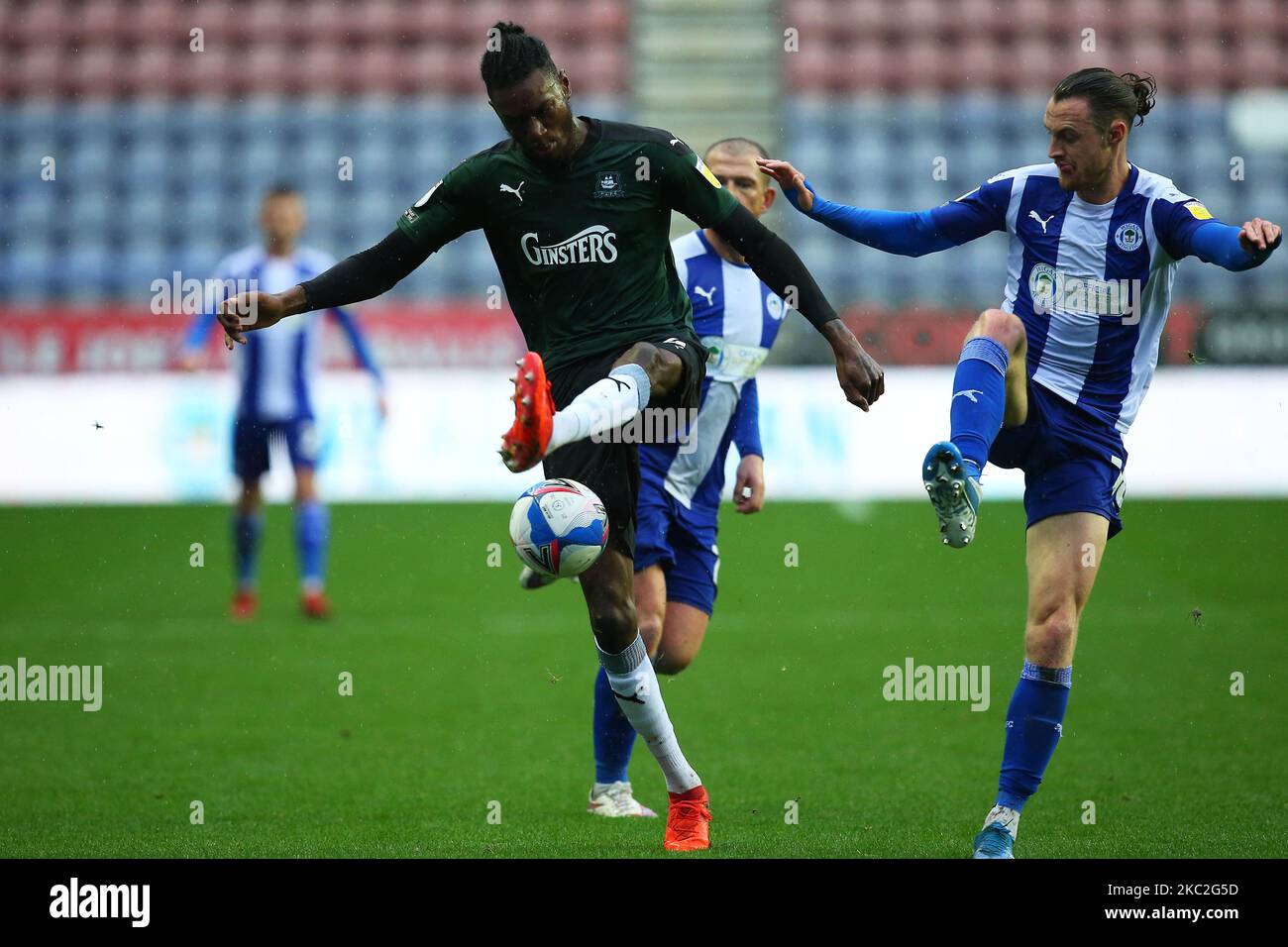Plymouths Jerome Opoku battles with Wigans Will Keane during the Sky ...