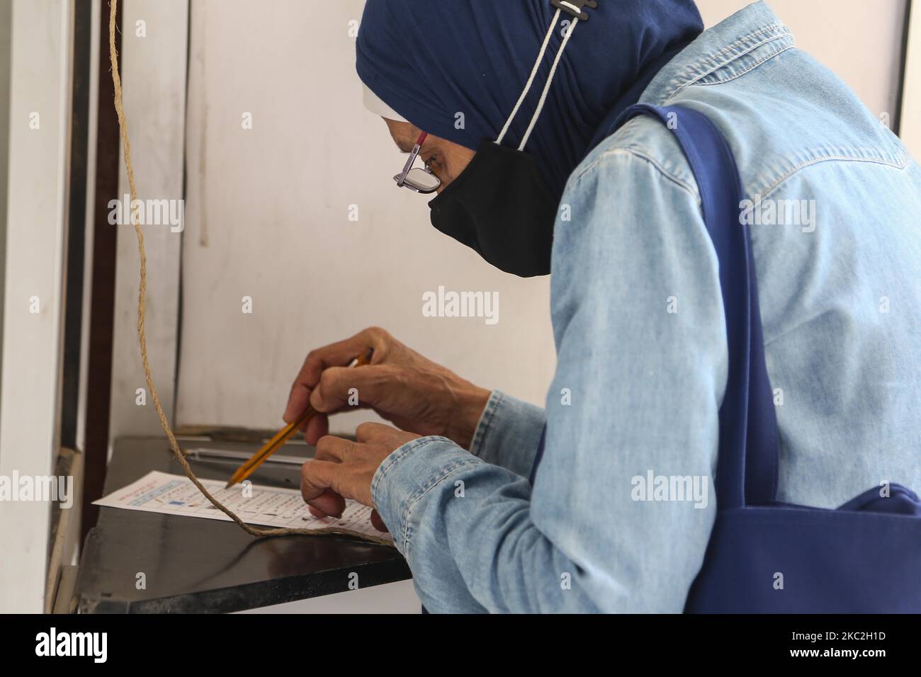 A woman vote inside a polling station at Dokki district during the ...