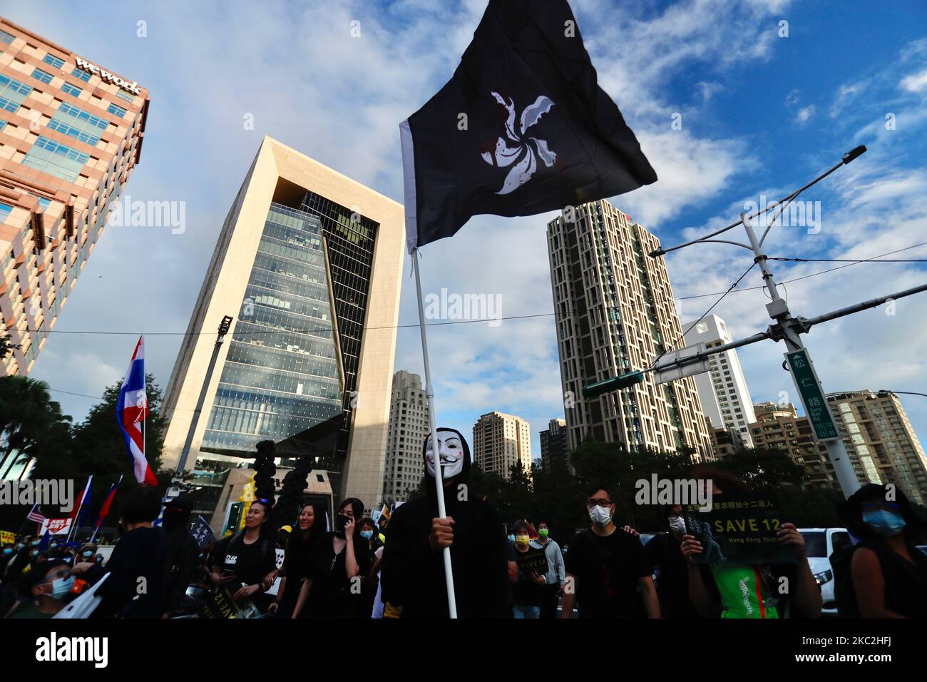 Approximately 3000 people wearing black bloc, holding signs and Hong ...