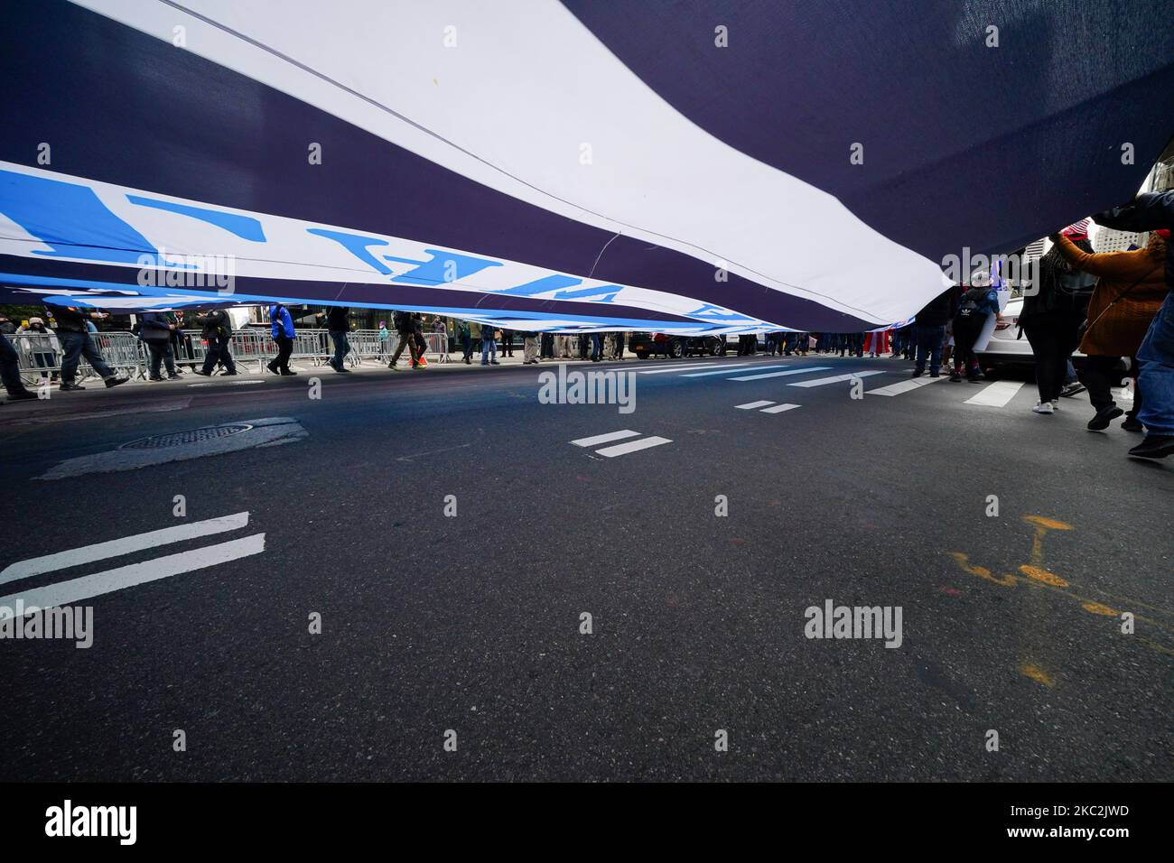 A huge flag with words that read, Trump Law and Order was carried by ...