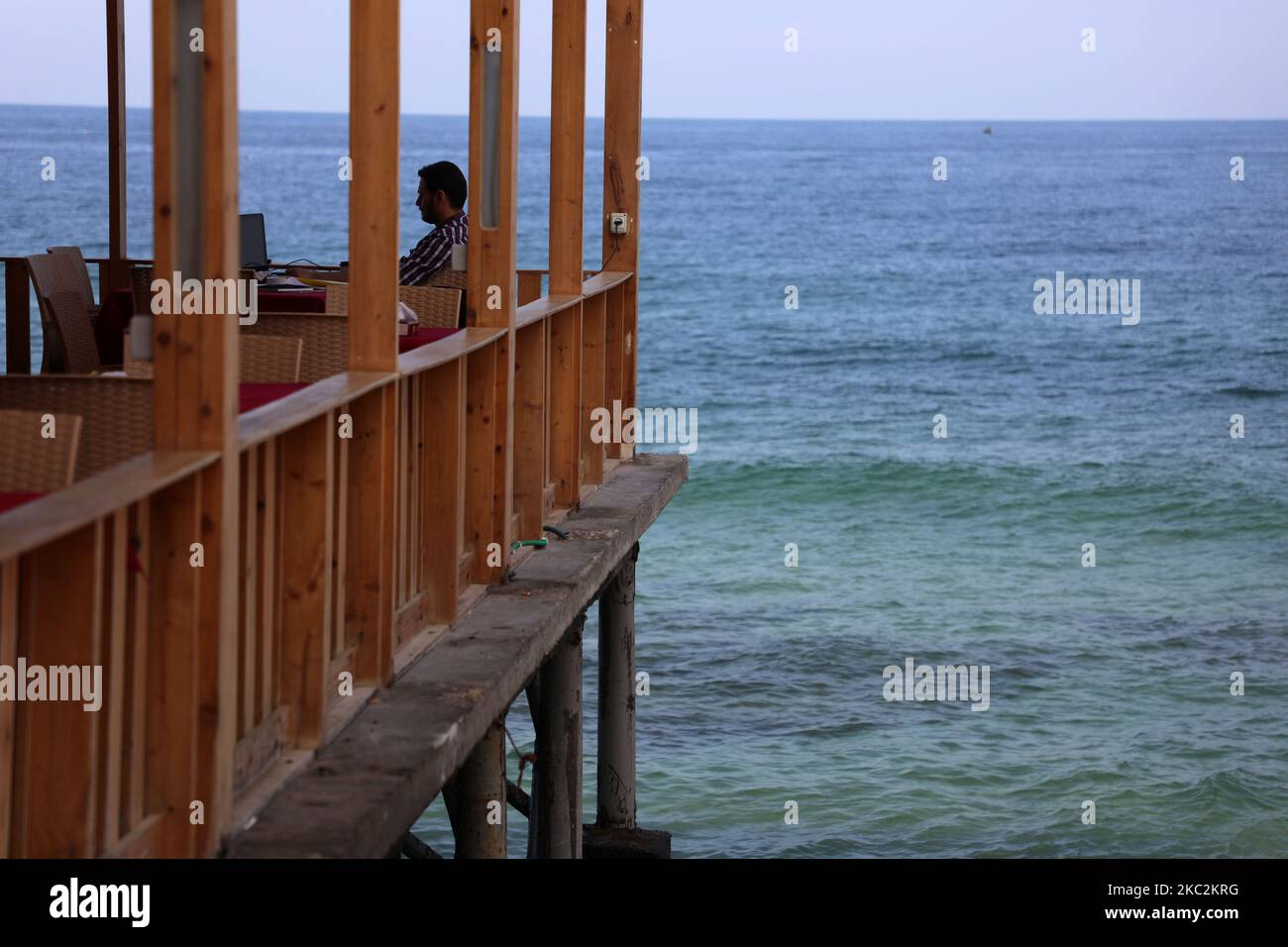 A Palestinian man enjoys his time at a beach side cafe in Gaza City ...
