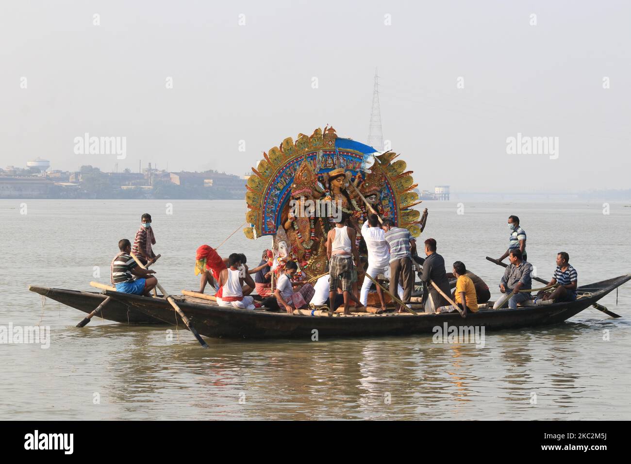 Indian Hindu devotees with an idol of Hindu Goddess Durga at the river ...