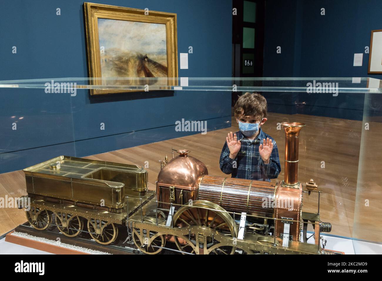 (EDITORIAL USE ONLY) A boy looks at steam locomotive model displayed ...