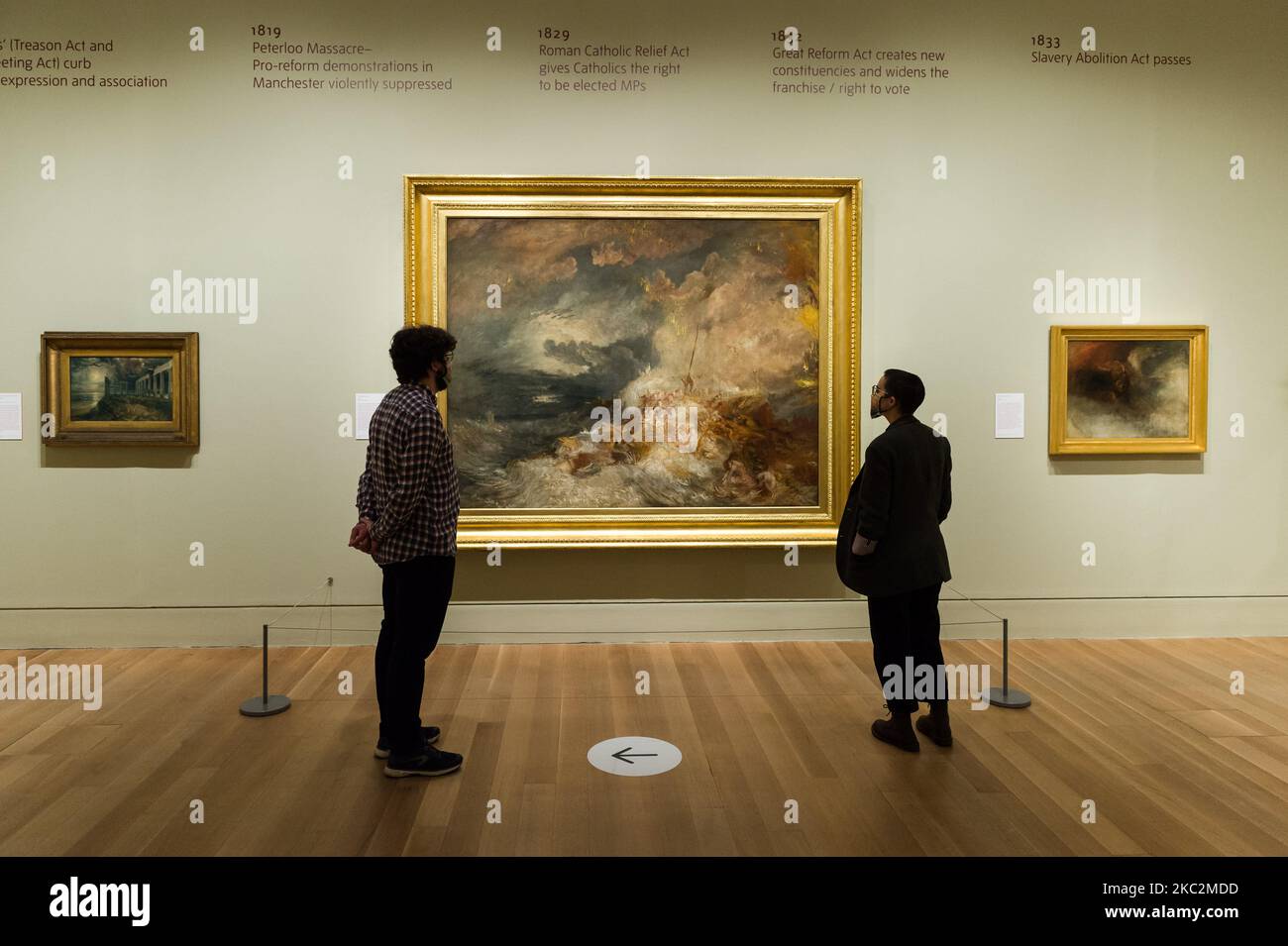 (EDITORIAL USE ONLY) Gallery staff members look at 'A Disaster at Sea ...