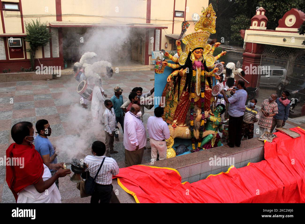 A priest performs Aarti (religious ritual of worship) for Goddess Durga ...