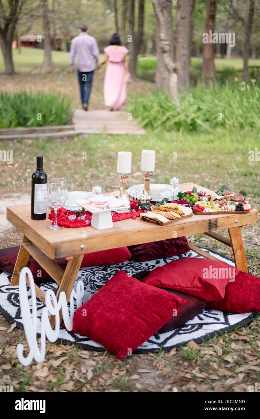 A romantic Valentine's Day couple's date night picnic with wine and ...