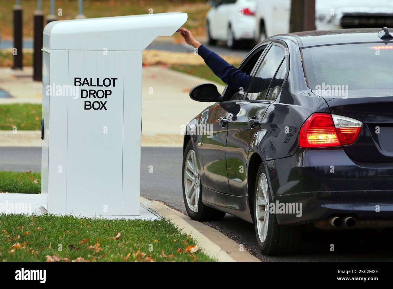 A drive-up voter drops off his election ballot for the 2020 General ...