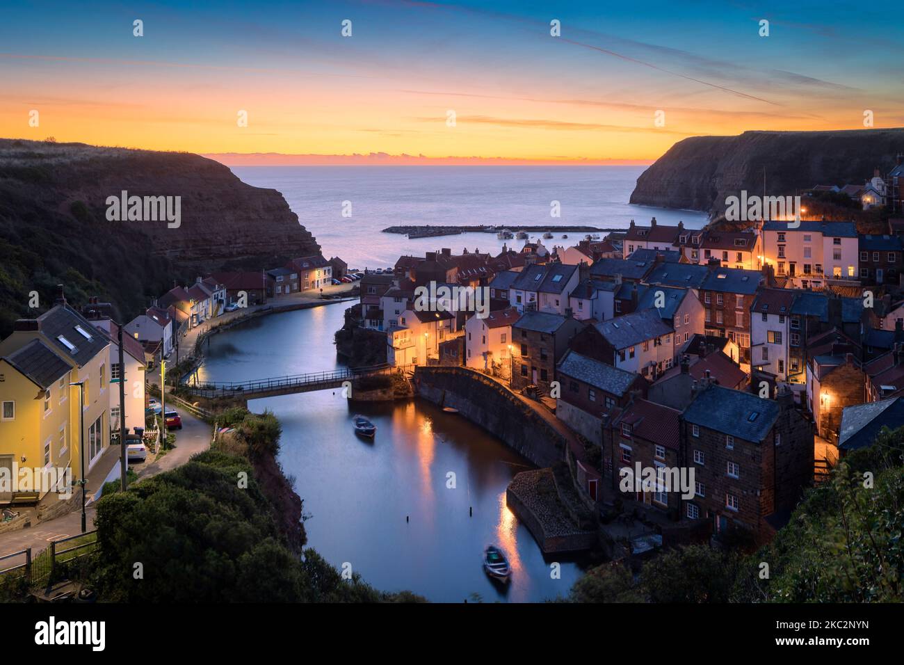 Dawn breaking over Staithes Harbour North Yorkshire England Stock Photo ...
