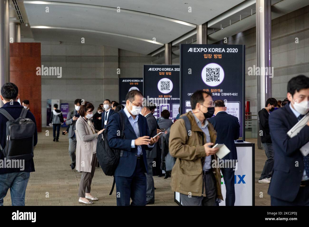 Visitors write QR code using their smartphones to enter the AI Expo ...