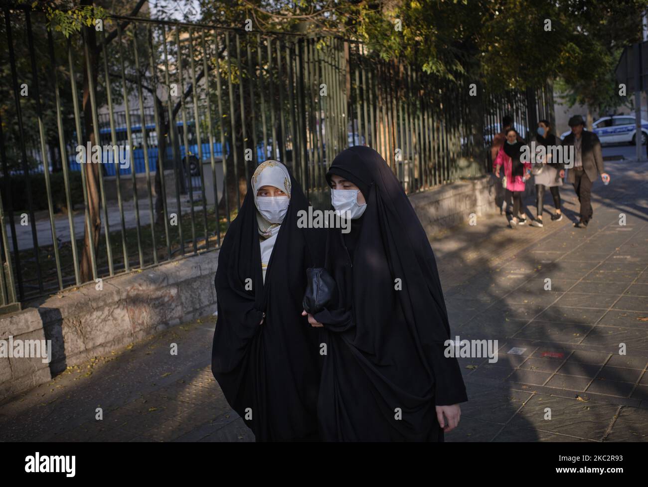 Two Iranian veiled women wearing protective face masks to prevent ...