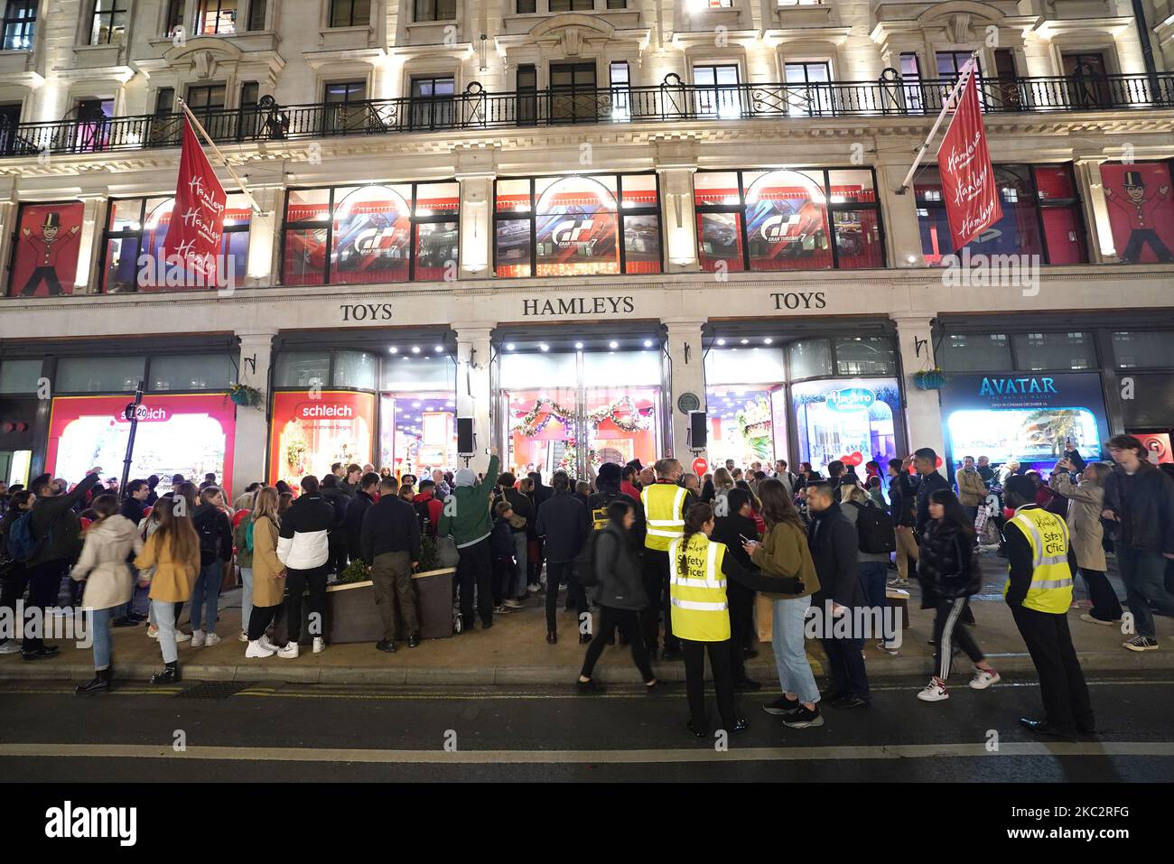 A crowd of people watching the unveiling of Hamleys Christmas windows ...
