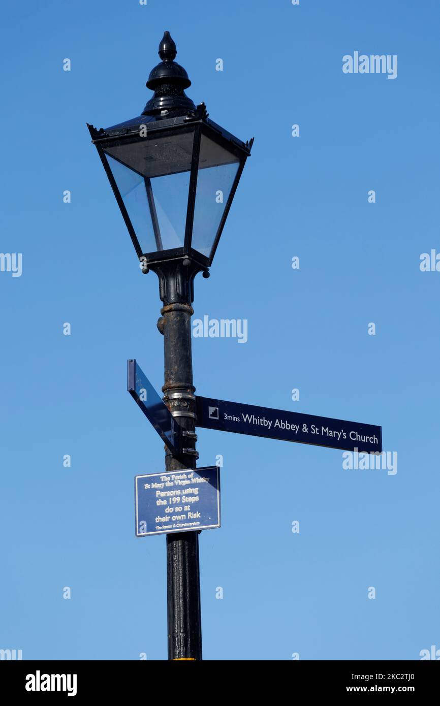 Typical directional signpost and lamp Whitby North Yorkshire England ...