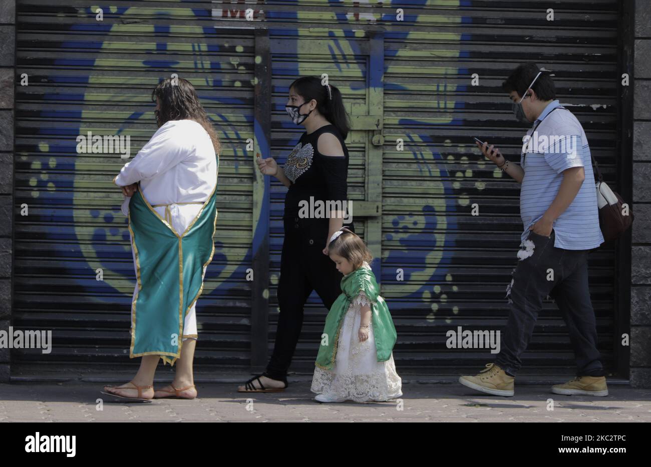 A girl and an adult disguised as San Judas Tadeo, the patron saint of ...