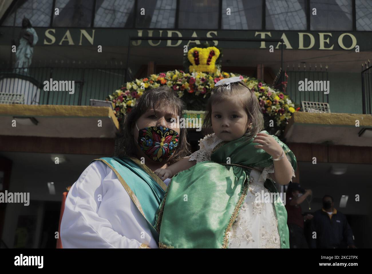A girl and an adult disguised as San Judas Tadeo, the patron saint of ...