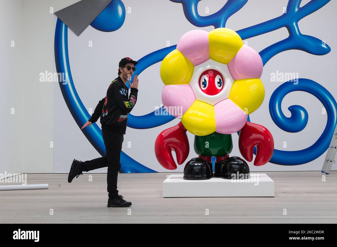 Pop artist Philip Colbert poses next to 'Lobster Flower' during the ...