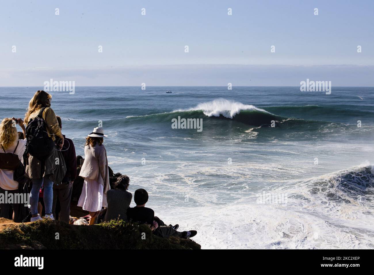 people watch surfer on the north beach, in Nazaré, on the day a giant ...