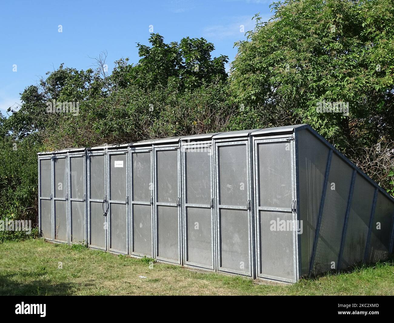 A close-up shot of bike boxes for parking in the park Stock Photo - Alamy