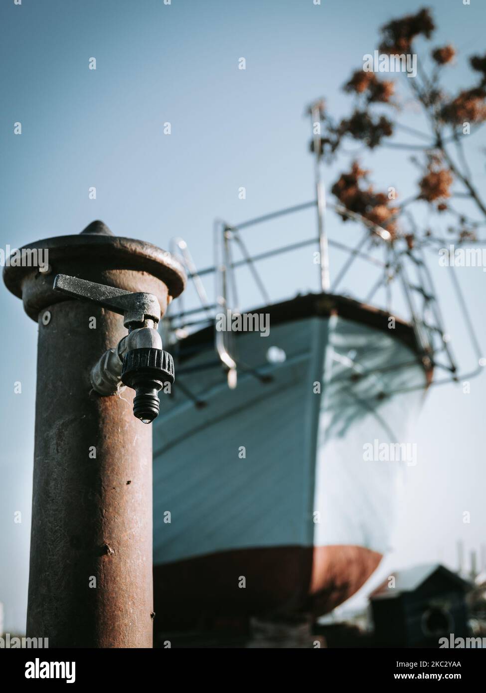 A vertical shot of a water tap with the background of a ship Stock ...