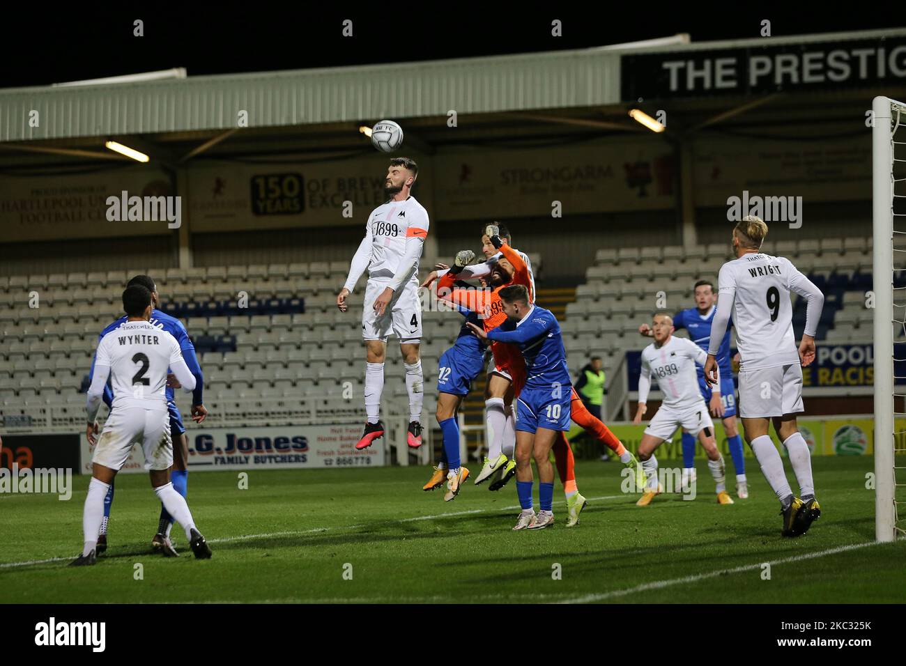Torquay United's Kyle Cameron heads clear from a corner during the ...