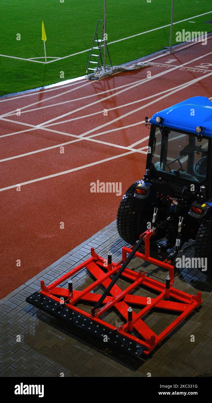 A vertical high-angle shot of an integrated synthetic turf groomer ...
