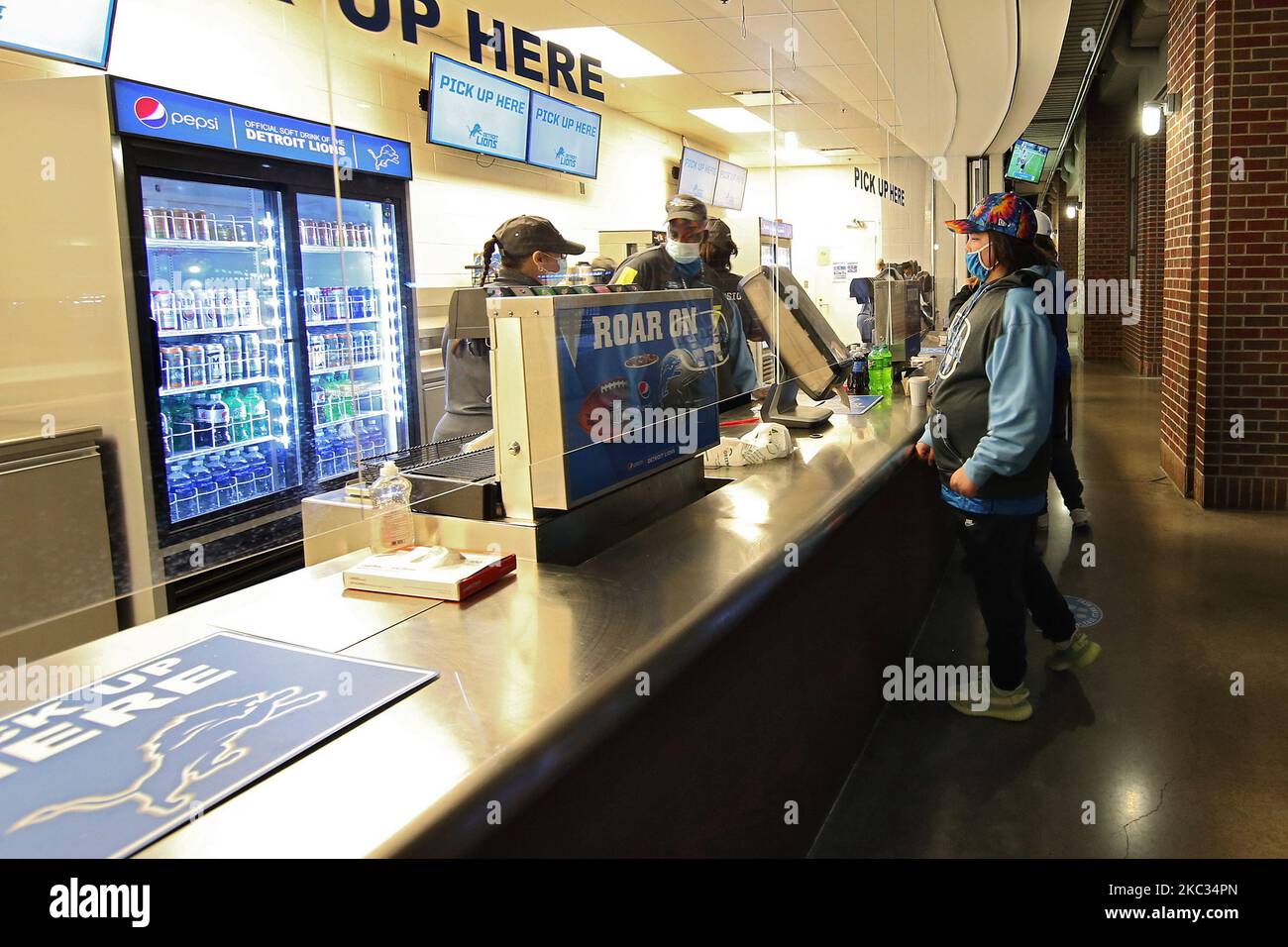 Fans order at the counter of a vendor on the Ford Field concourse at ...