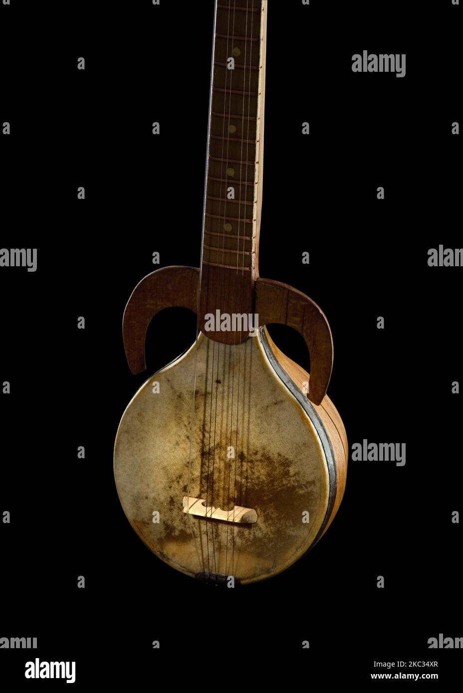 An ancient Asian stringed musical instrument on a black background ...