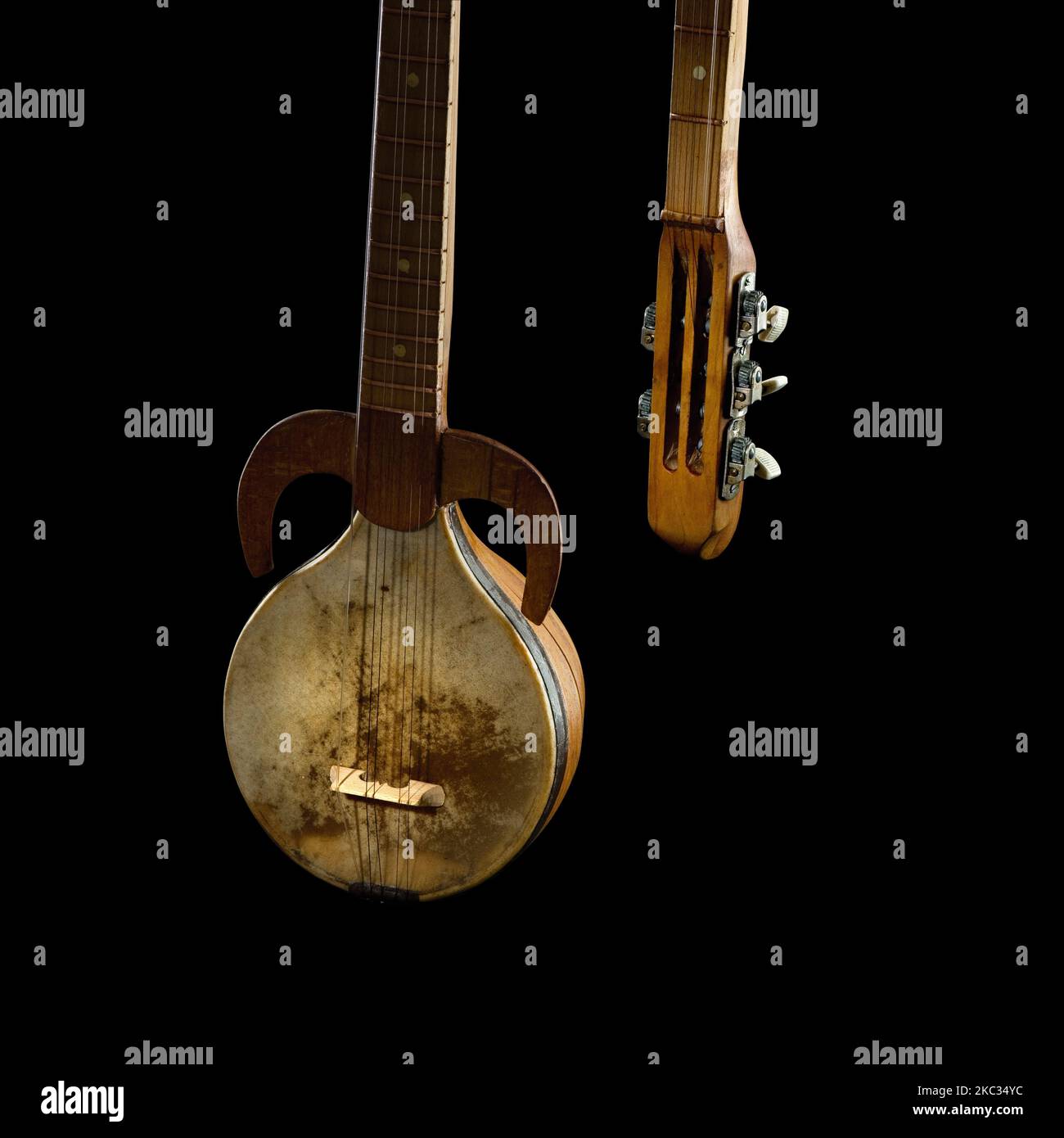 An ancient Asian stringed musical instrument on a black background ...