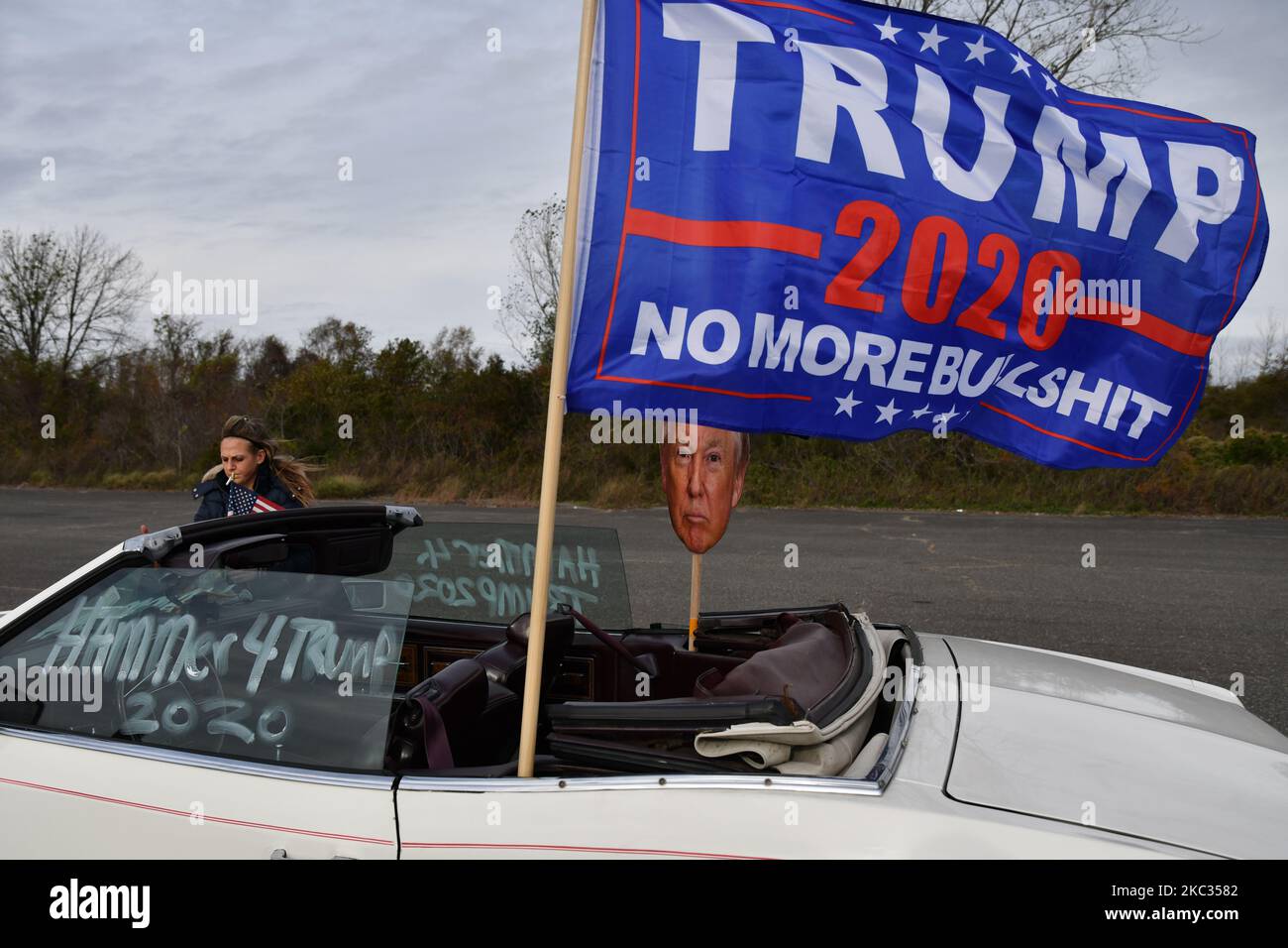 A caravan of nearly 400 cars bearing Trump signs and flags clogged ...