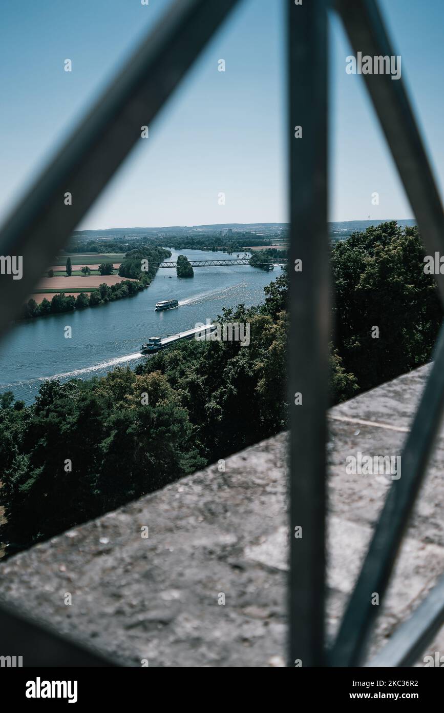 A vertical shot through a metal fence of a beautiful sea view with ...