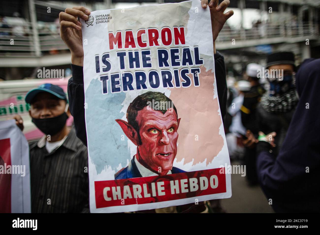 A man hold placards during a demonstration against French President ...
