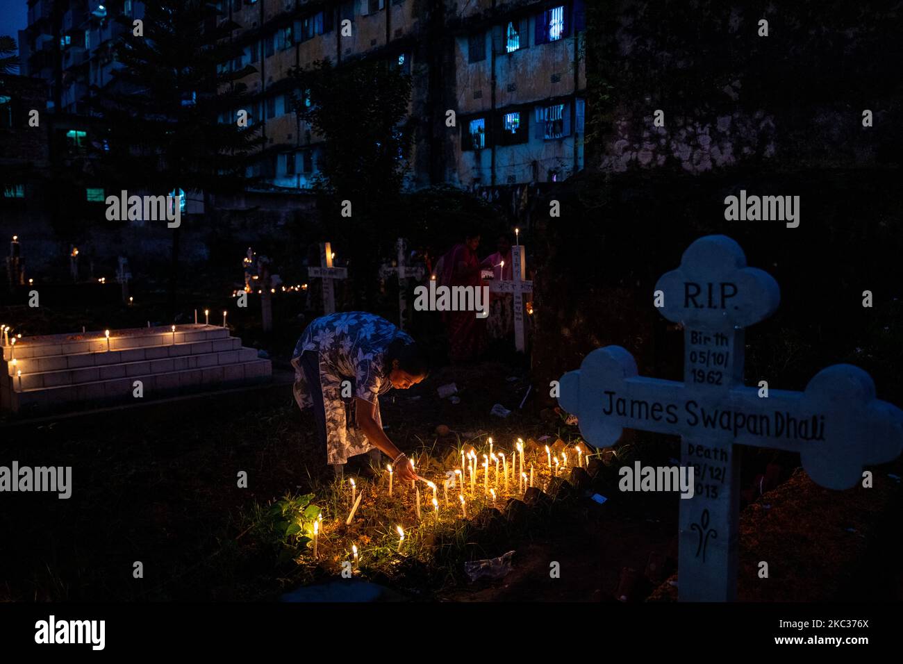 Christians pray at the graves of their relatives during the observance ...