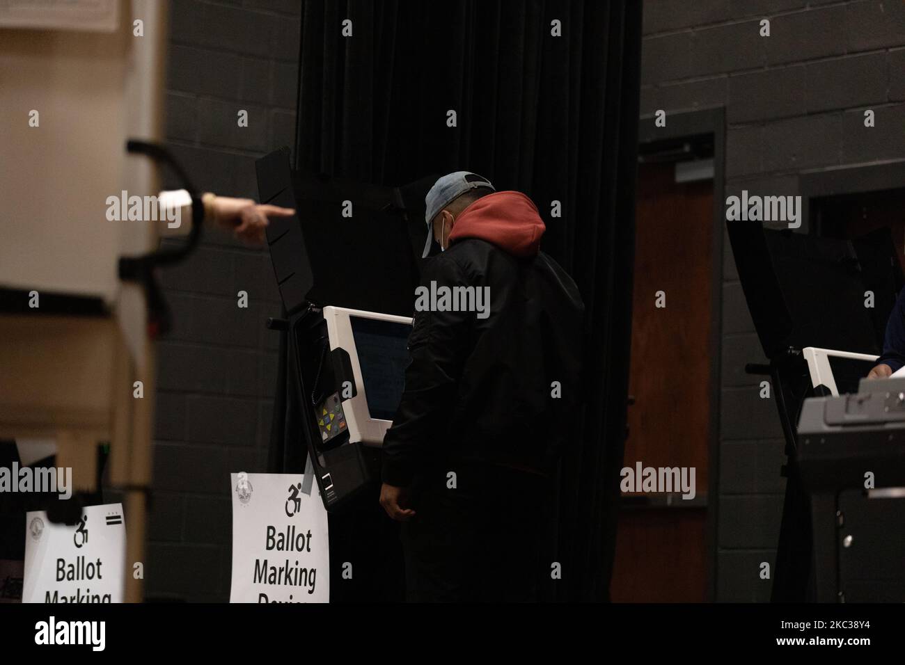 A person prepares to vote at voting station during Election Day in ...