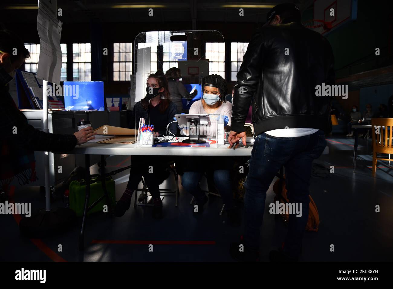 Poll workers register voters at the poll site at PS 192 in New York ...