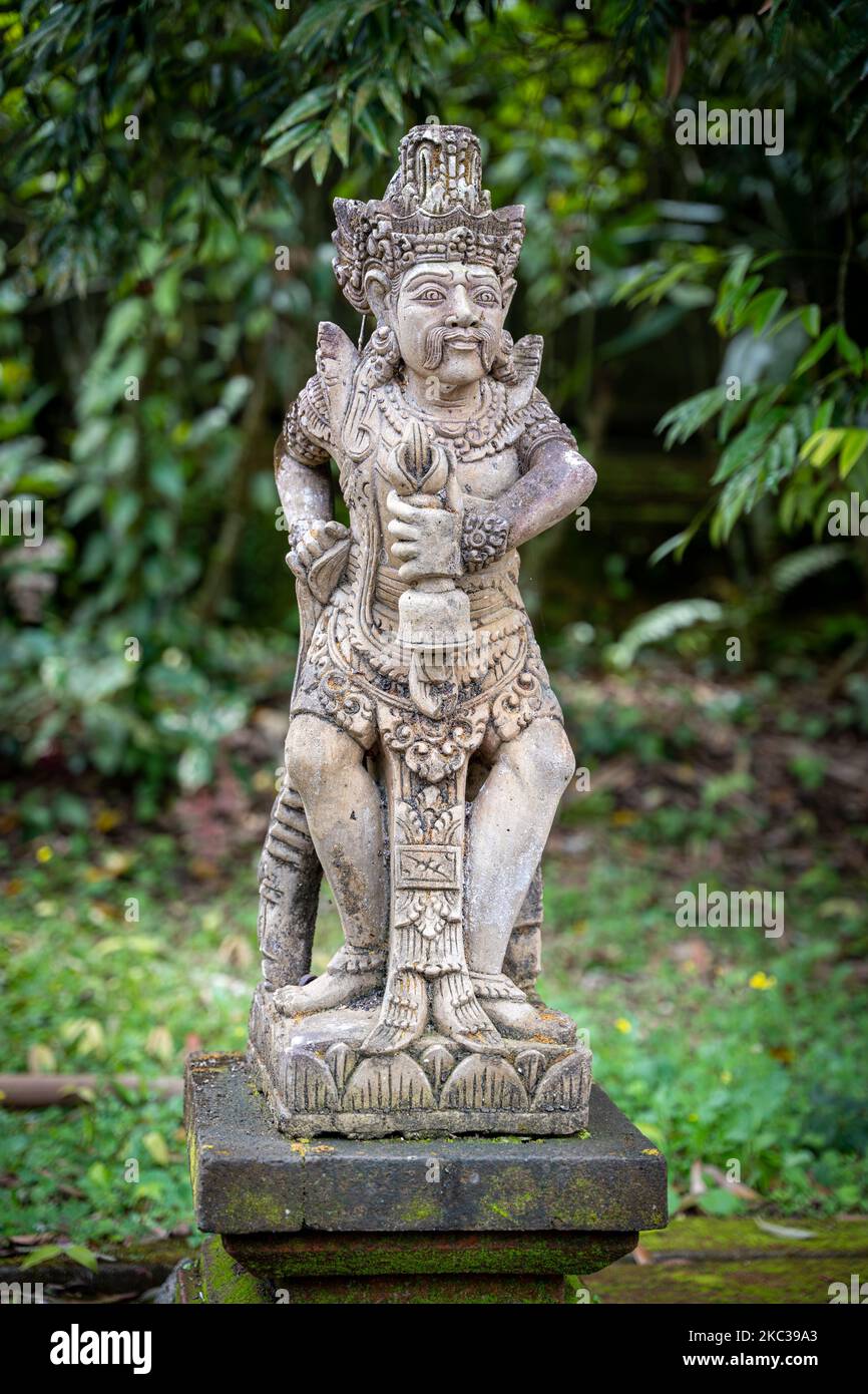 A vertical closeup of ancient statue in a temple in Bali, Indonesia ...