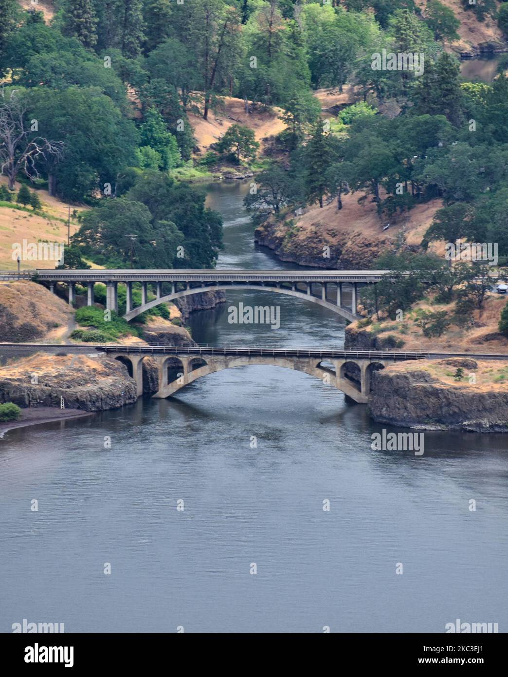 An aerial of a concrete arch bridge over the Klickitat river bridge ...