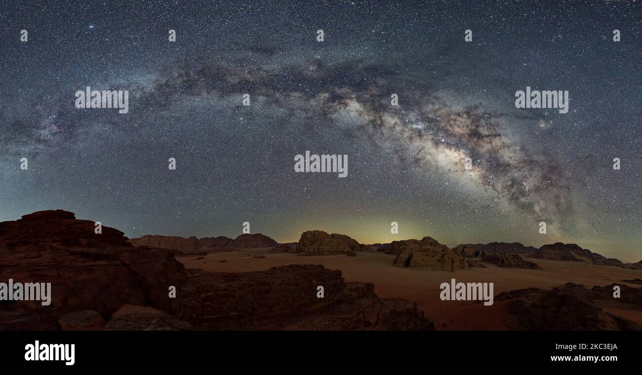The Milky way with the starry night background over the dessert land ...
