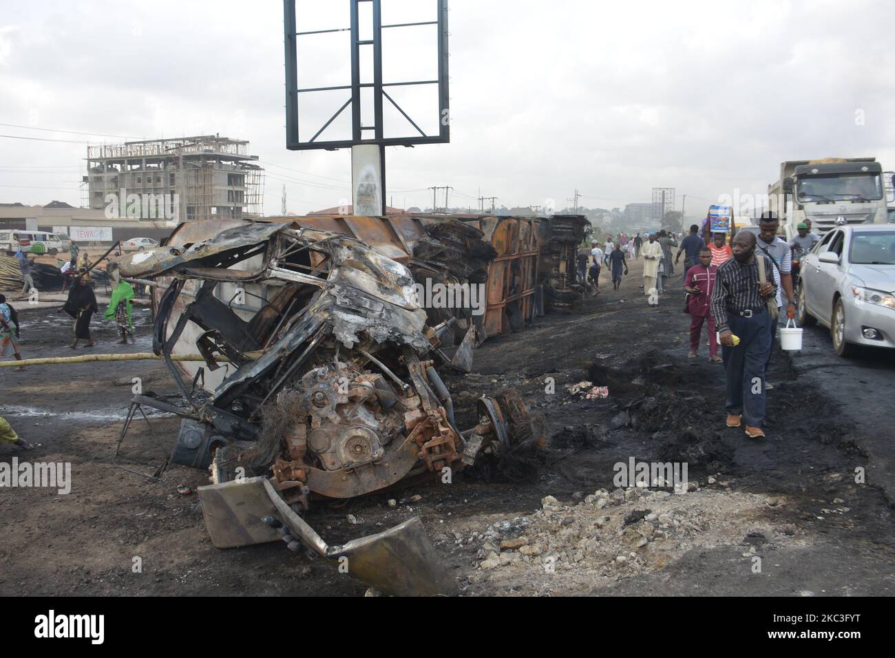 Passersby walk amid burned cars after a tanker exploded on Lagos-Ibadan ...