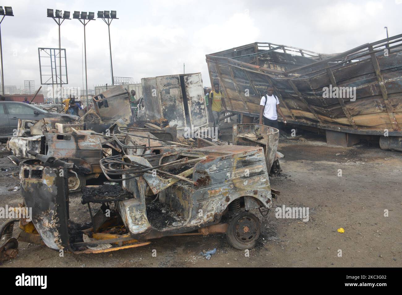 Passersby walk amid burned cars after a tanker exploded on Lagos-Ibadan ...
