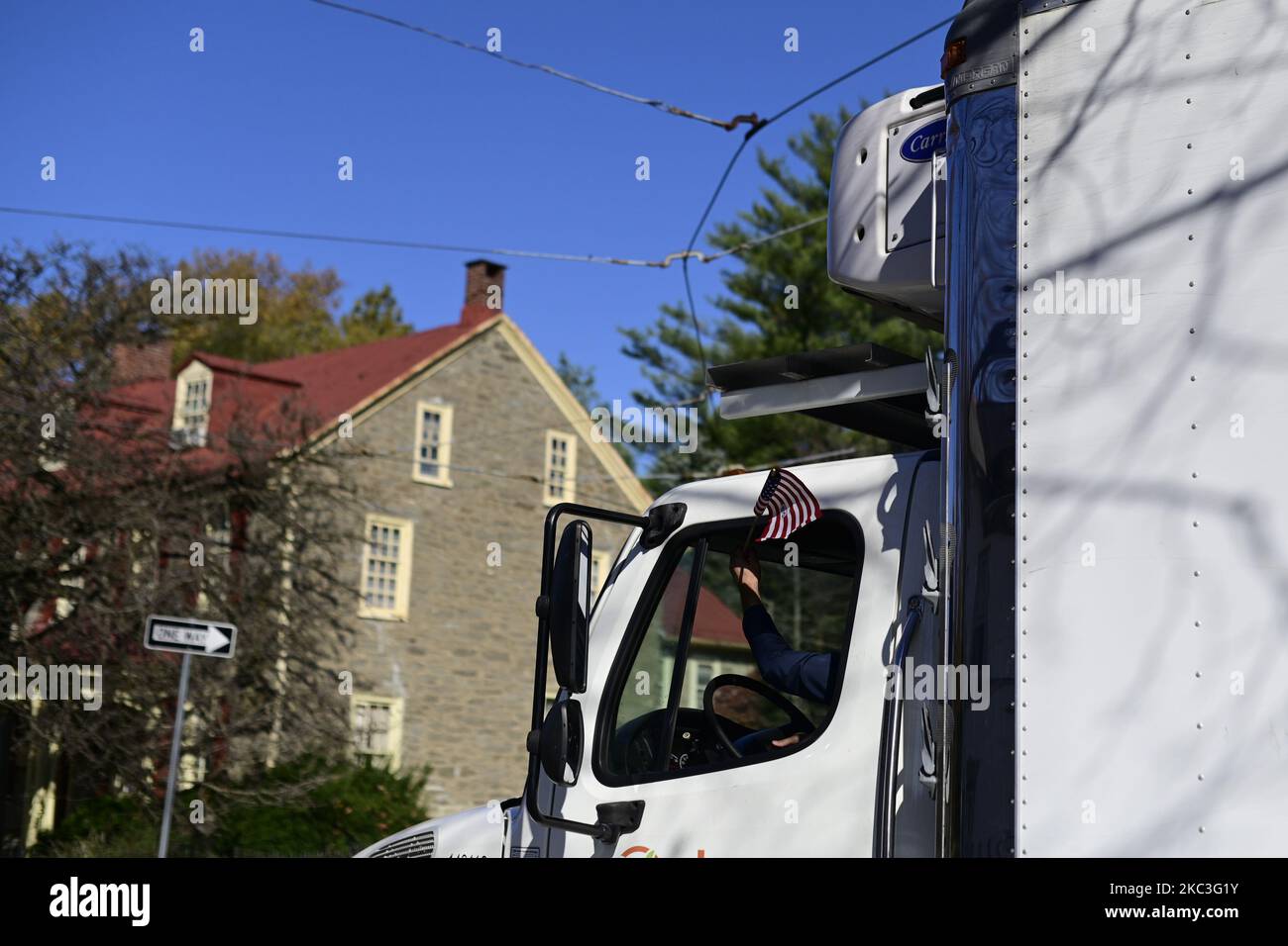 A trucker waves a small American flag as Philadelphians celebrate after ...