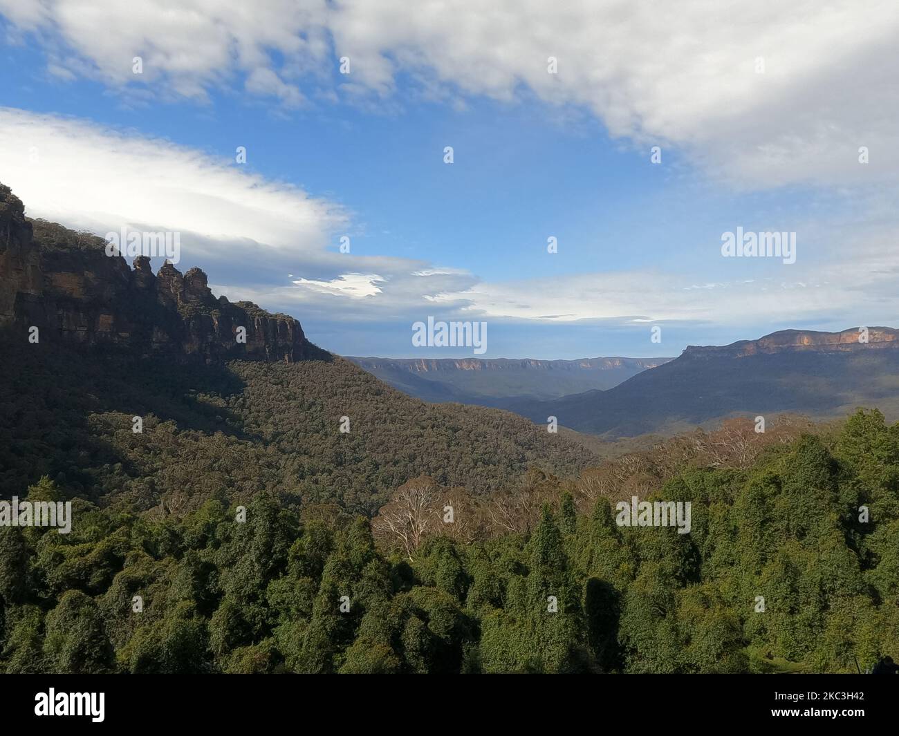The beautiful view of cliffs covered with green vegetation. Blue ...