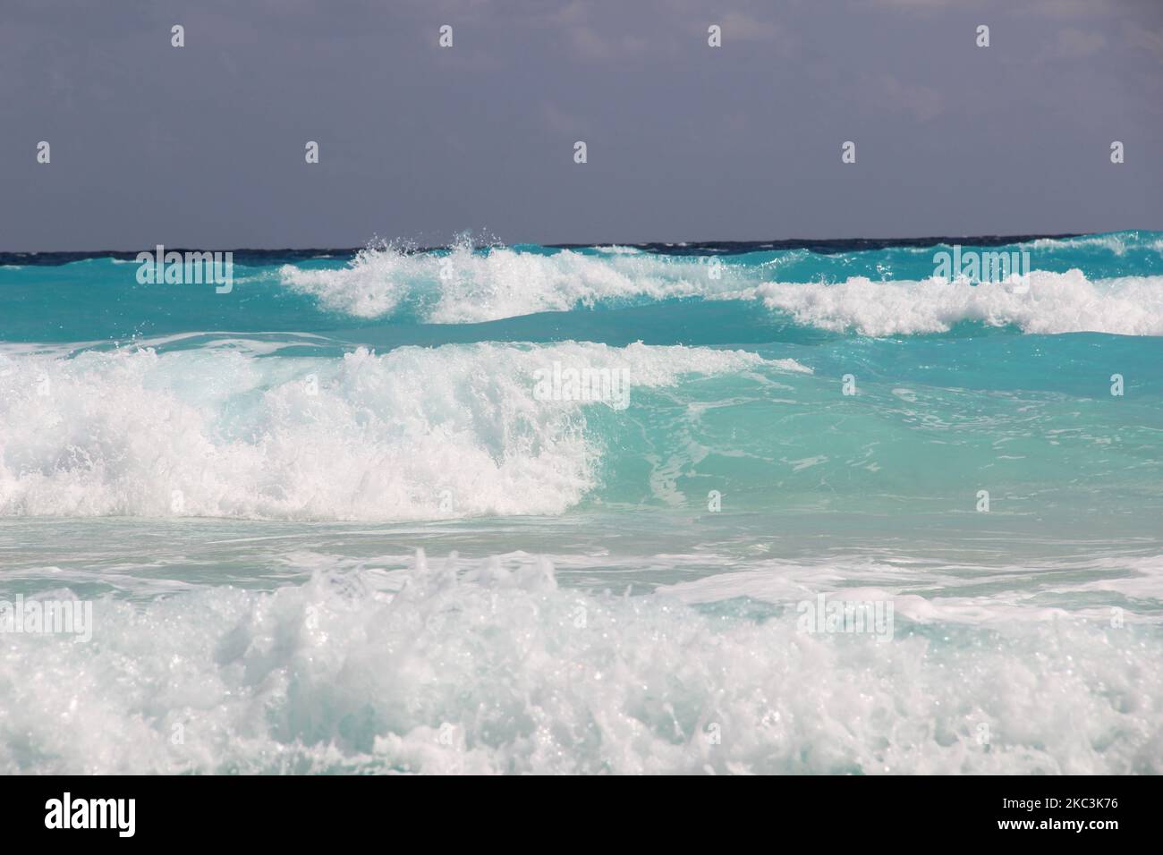 The foamy waves splashing in a turquoise sea background Stock Photo - Alamy