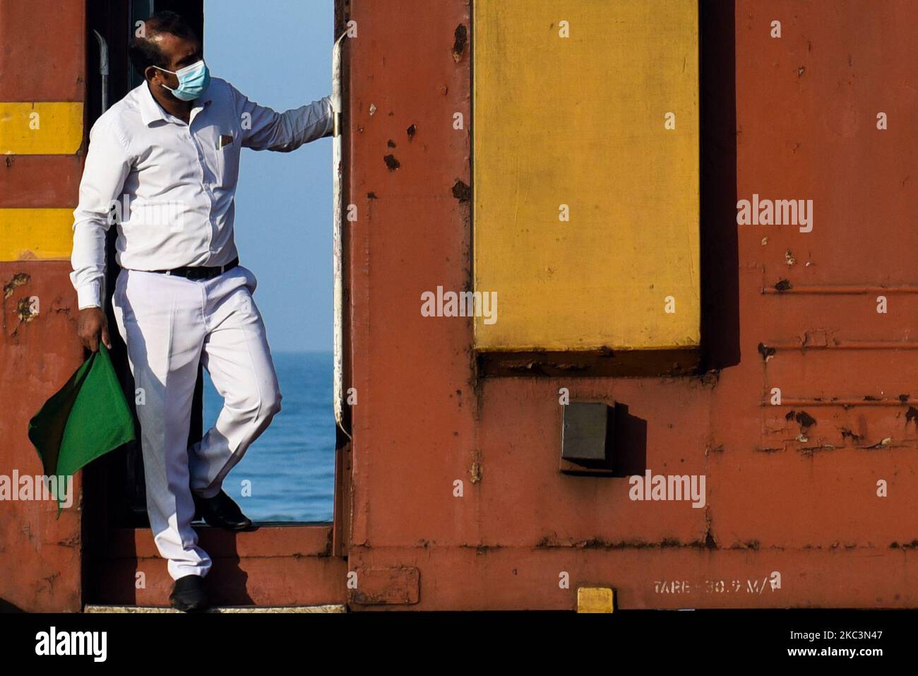A railway worker aboard a train, after trains resumed work following ...