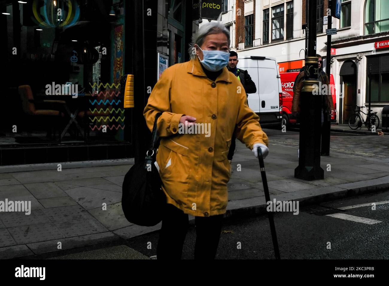 People wear mask as they walk along Regent Street, in London on ...