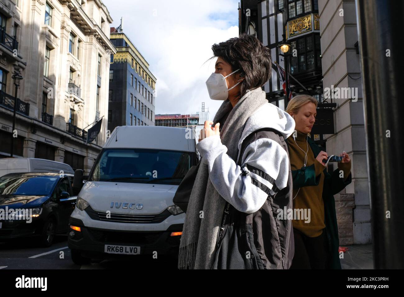People wear mask as they walk along Regent Street, in London on ...
