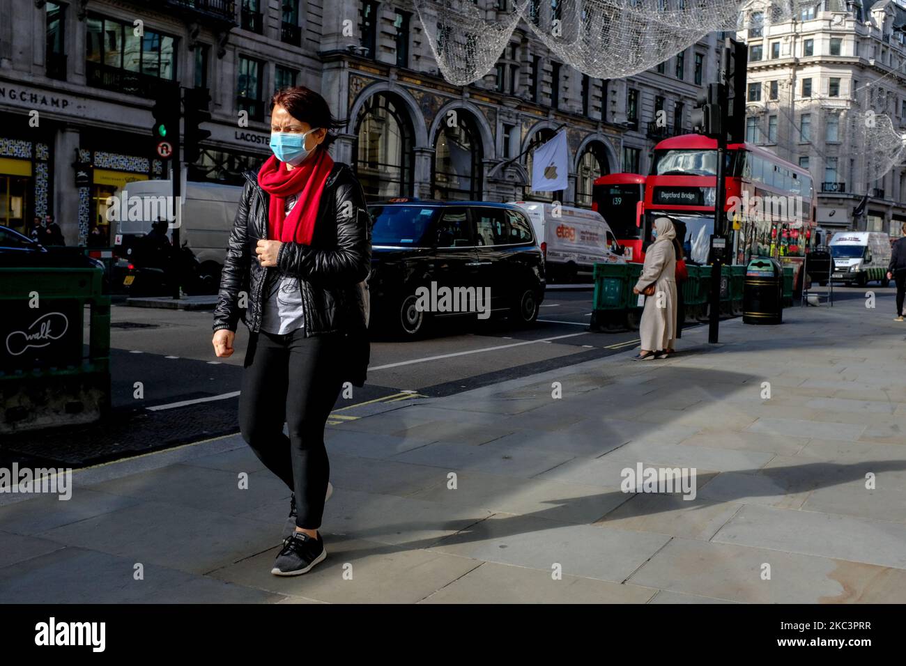 People wear mask as they walk along Regent Street, in London on ...